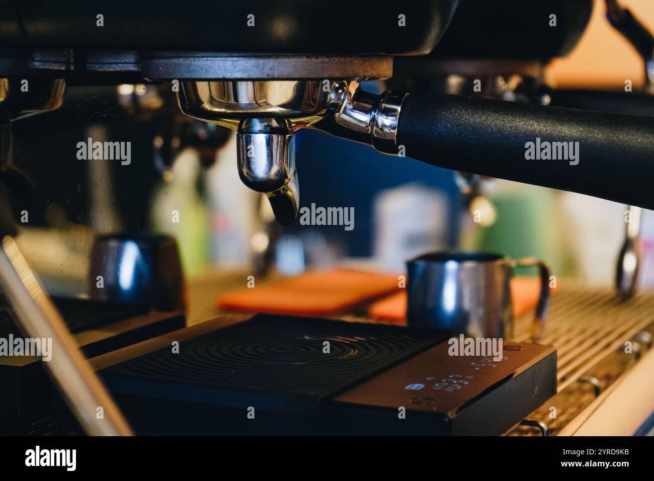 A close-up of a sleek café coffee machine captures its shiny steel ...