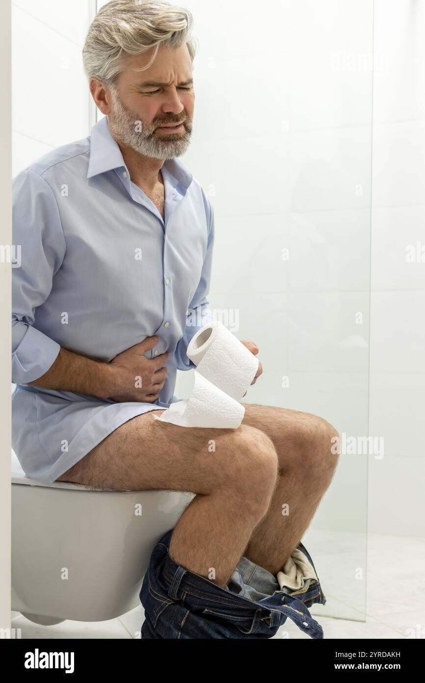 Man sitting in a toilet and having problems with digestion Stock Photo ...