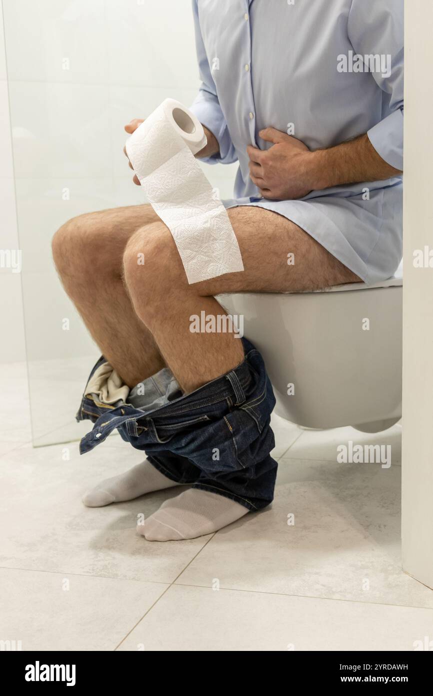 Man sitting in a toilet and having problems with digestion Stock Photo ...