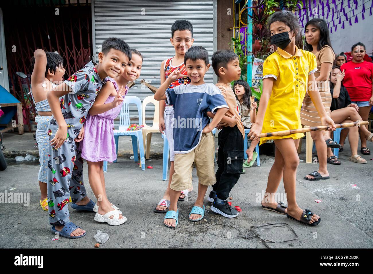 Crowds of cute Filipino children all happily pose and smile for the camera in The Tondo District ...