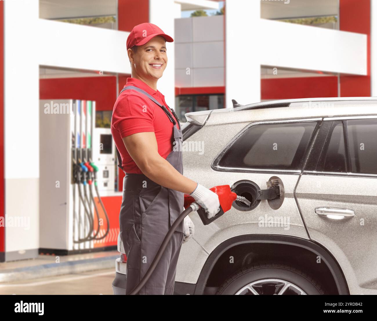 Male worker filling a SUV with fuel at a gas station Stock Photo - Alamy
