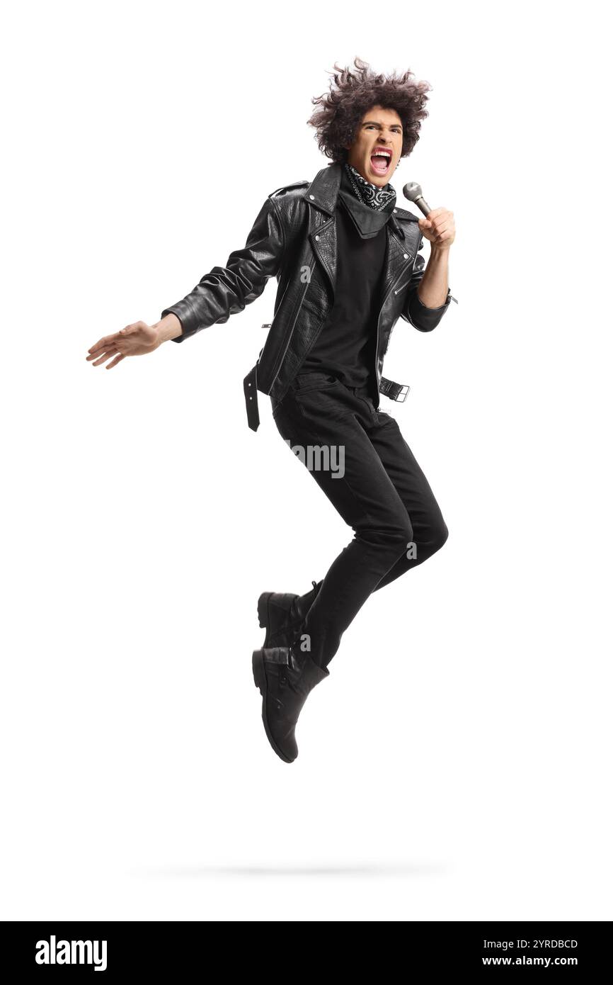 Male singer jumping and holding a microphone isolated on white ...