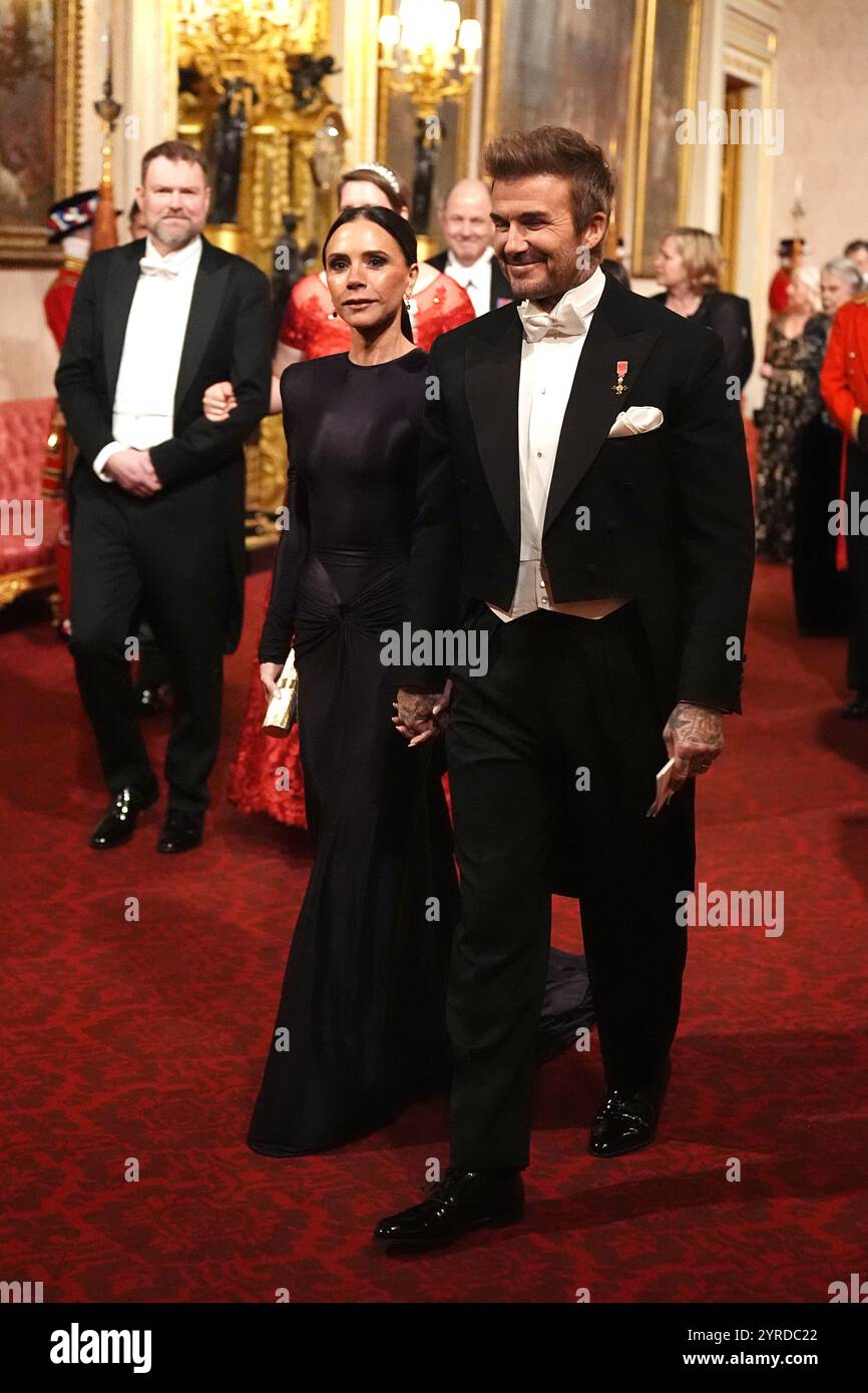 David and Victoria Beckham make their way along the East Gallery to ...