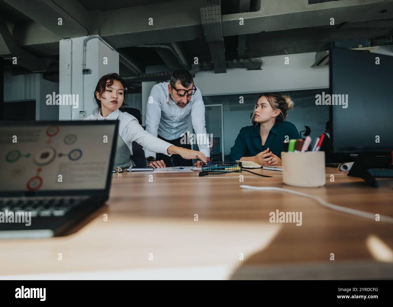 Business team strategizing and discussing projects in modern office ...