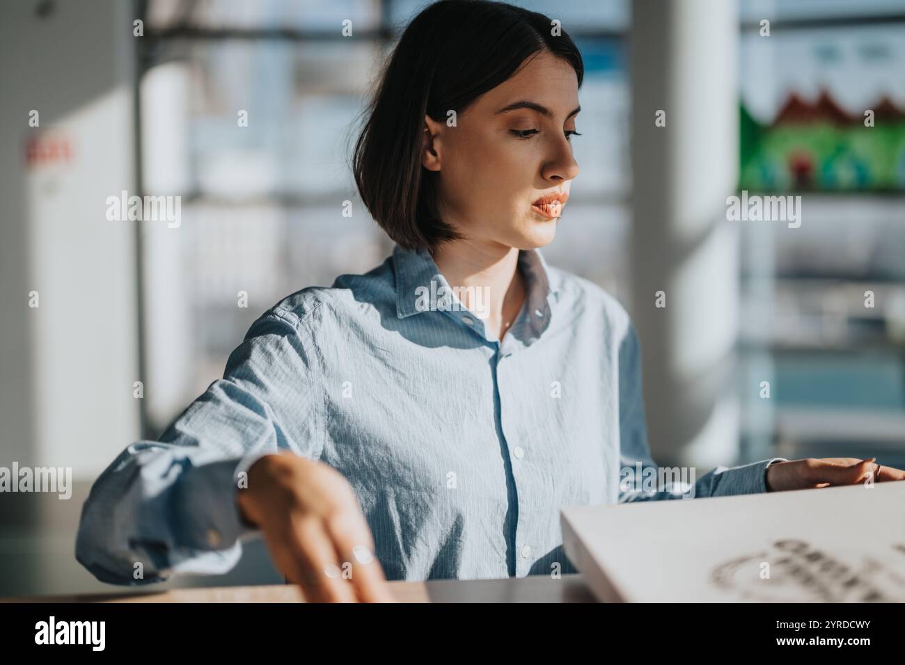 Focused professional woman strategizing project tasks in modern office ...