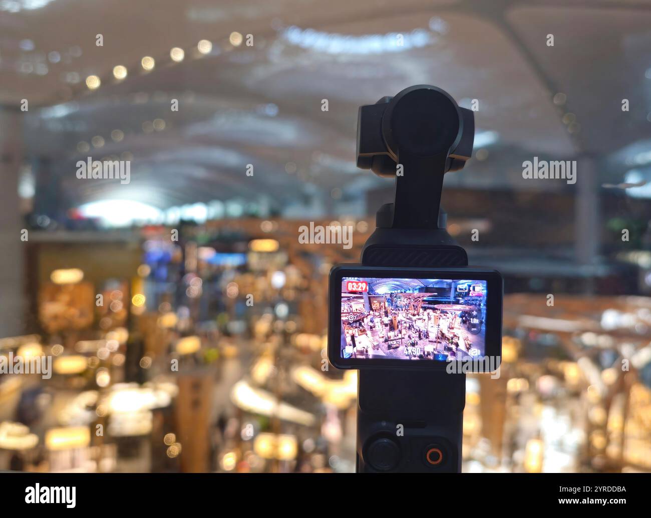 Osmo pocket 3, portable handheld camera recording in a large venue. The ...
