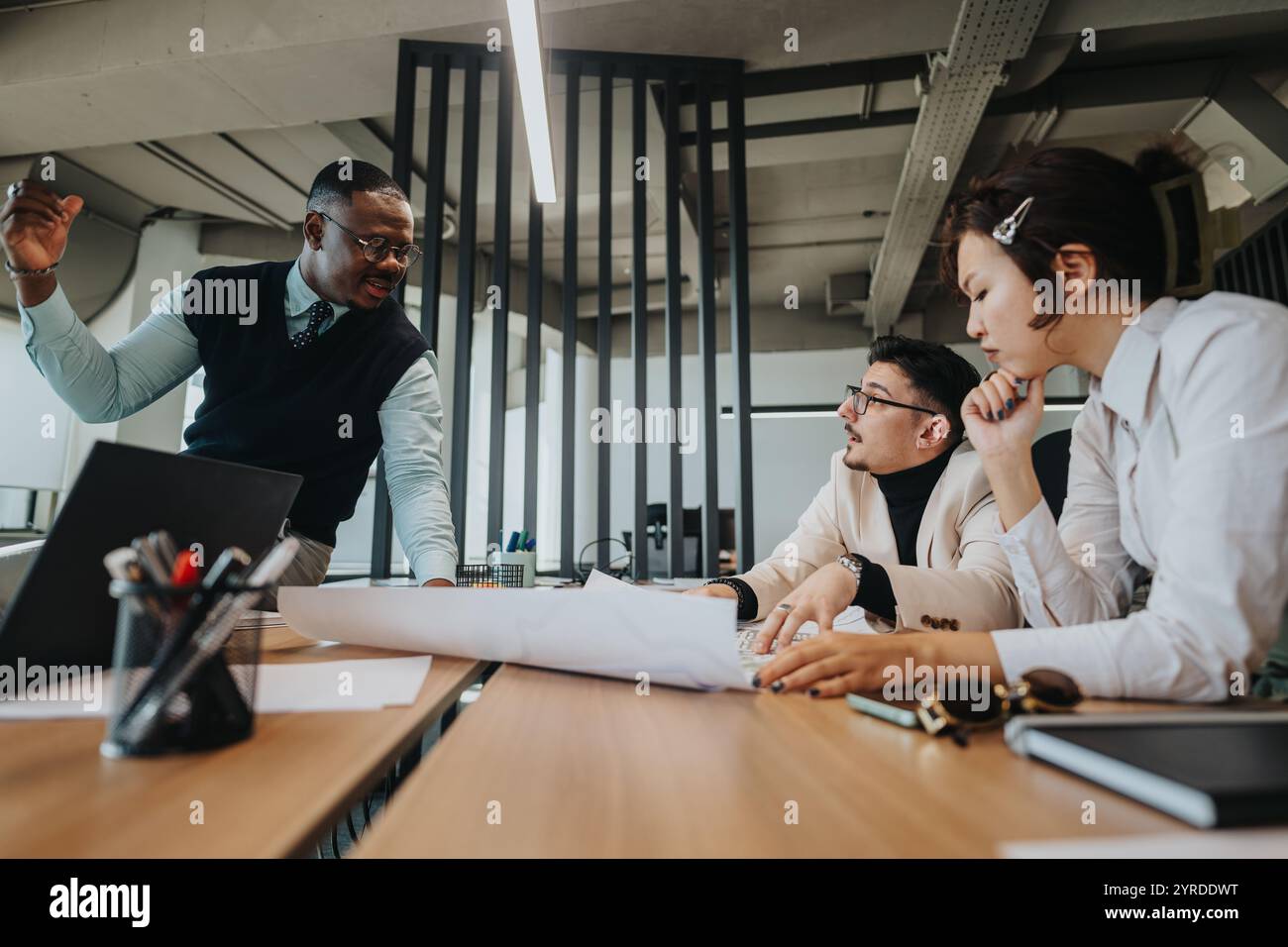 Team brainstorming session in a modern office environment Stock Photo ...