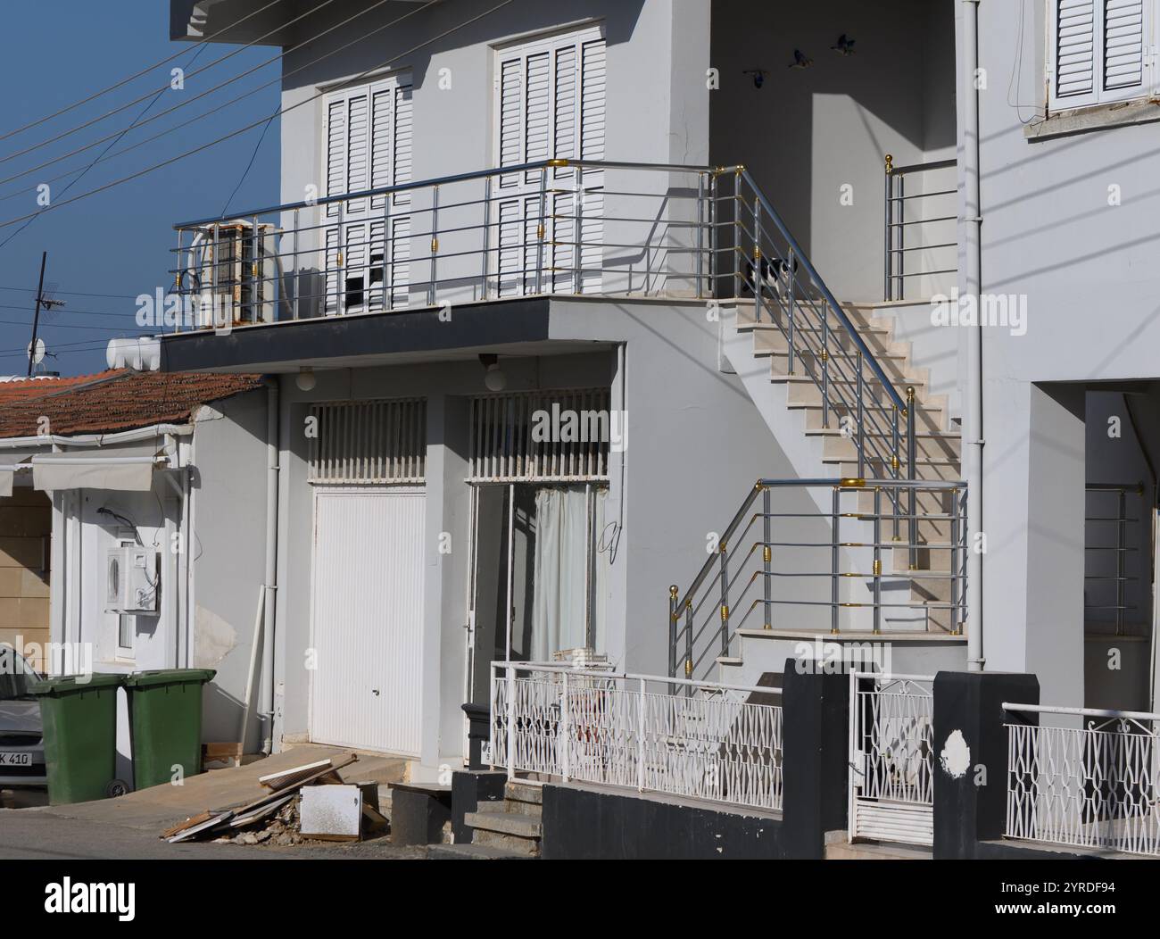 A coastal building features a modern facade with a prominent staircase ...