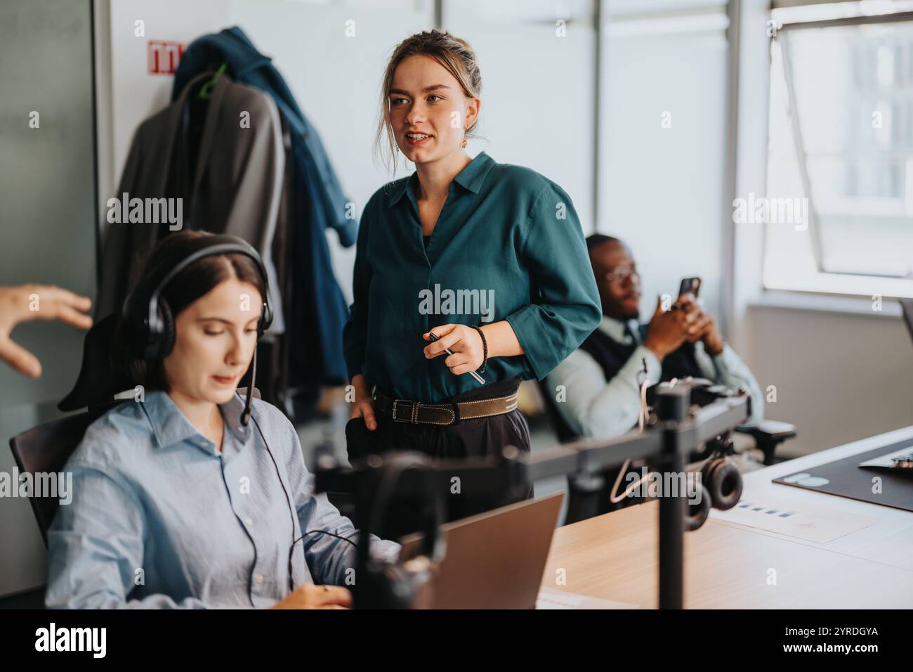 Business employees collaborating in modern office setting with ...