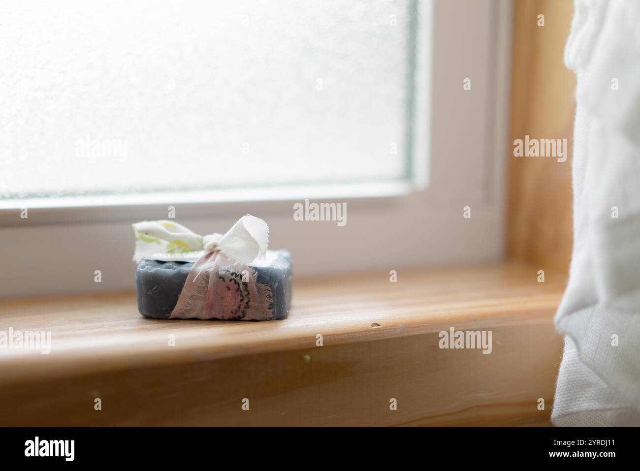 Handmade Charcoal Soap Wrapped in Fabric Ribbon on a Wooden Window Sill ...