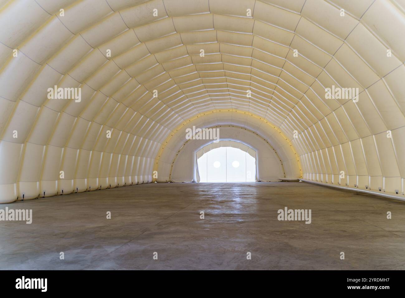 An expansive, white dome structure features a smooth, curved interior ...
