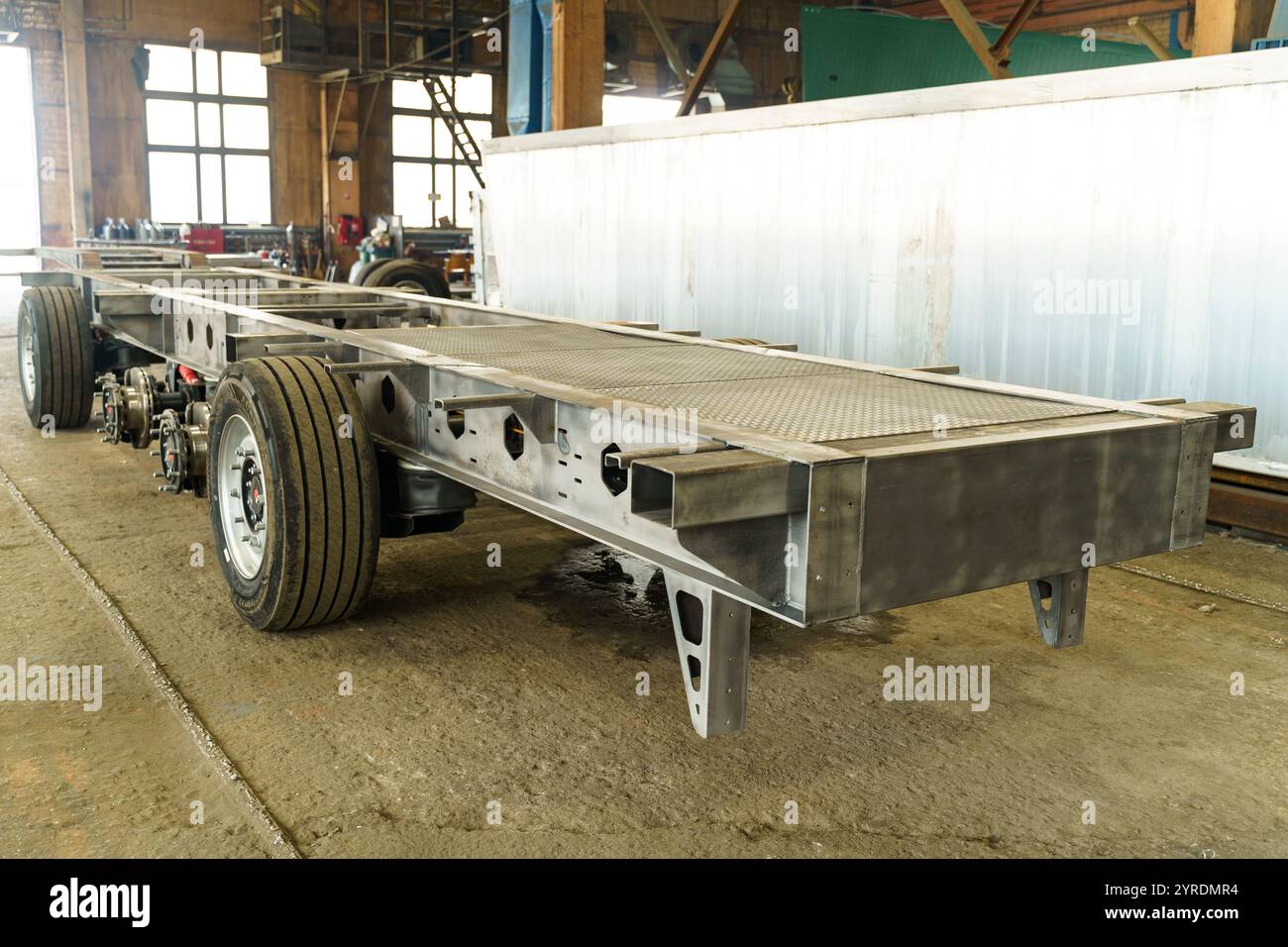 A well-crafted truck chassis is showcased in an active workshop ...