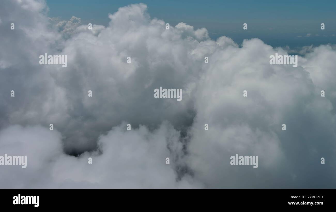 Flying through white clouds over sea Stock Photo - Alamy