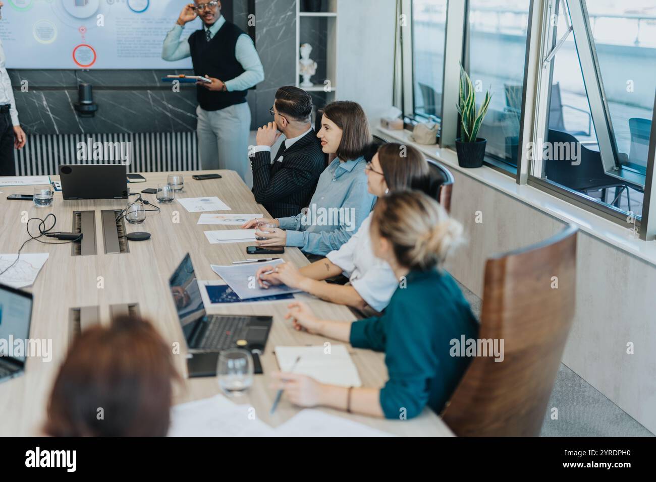 A diverse group of business people engage in a collaborative meeting ...