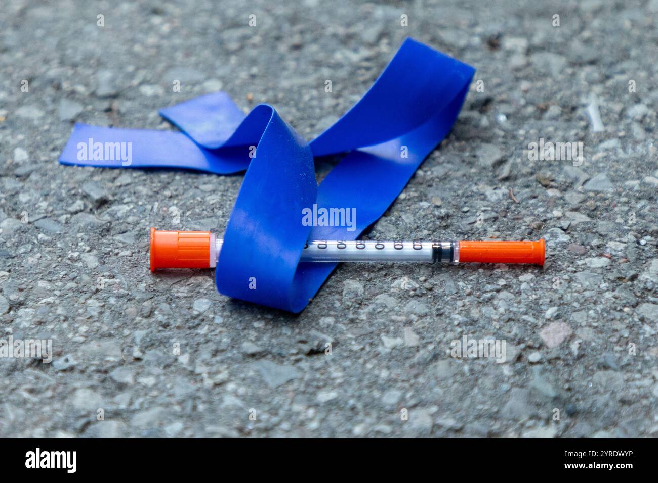 A discarded syringe is seen on a downtown path. The closure of safe ...