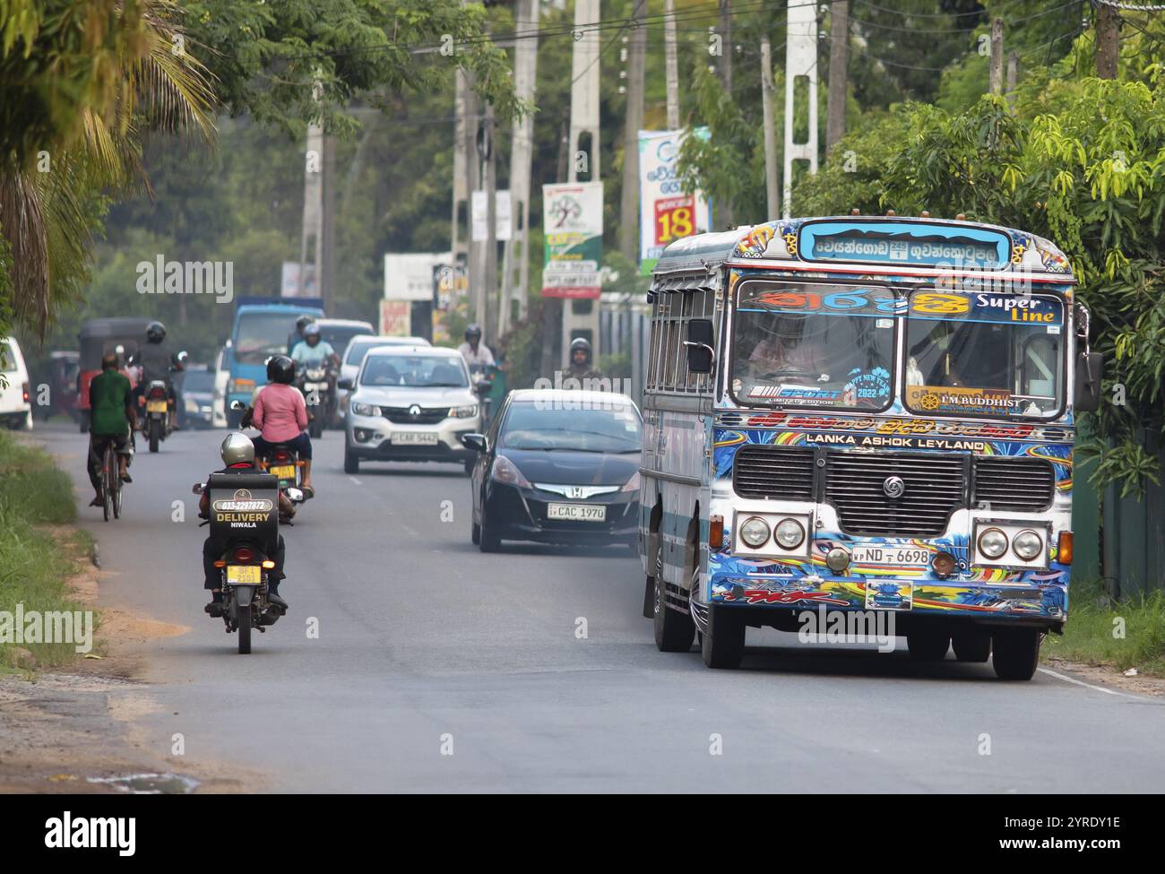 Street scene, colourful bus, cars, mopeds, Veyangoda, Western Province ...