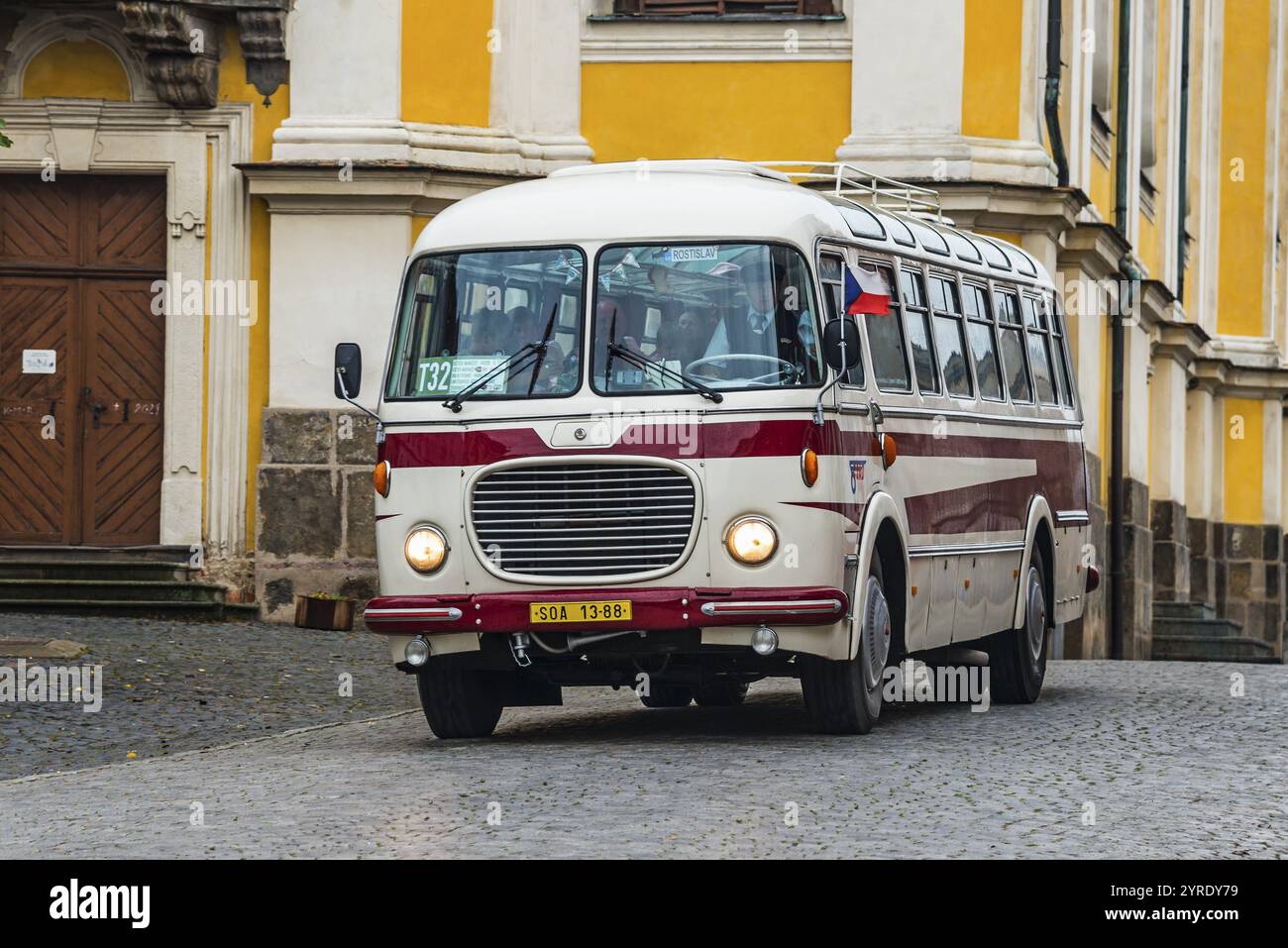 A traditional bus in front of a magnificent yellow historical building ...