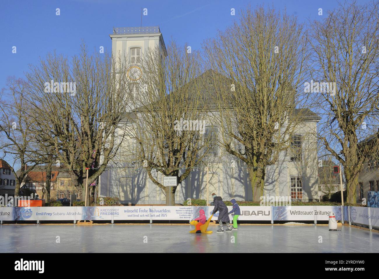 Ice rink with children ice skating at the Christmas market with early ...