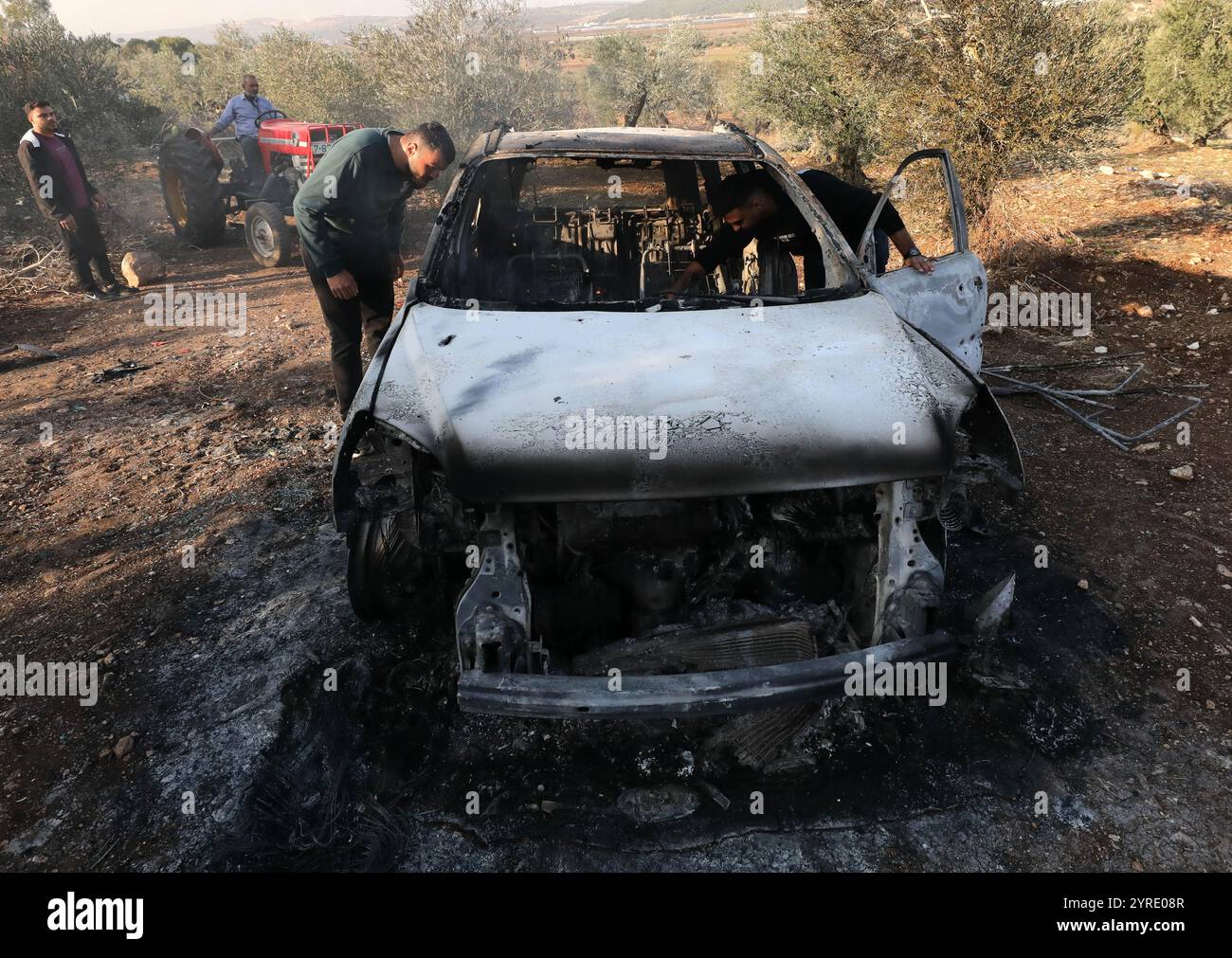 Tubas, West Bank. 3rd Dec, 2024. People look at the wreckage of a ...