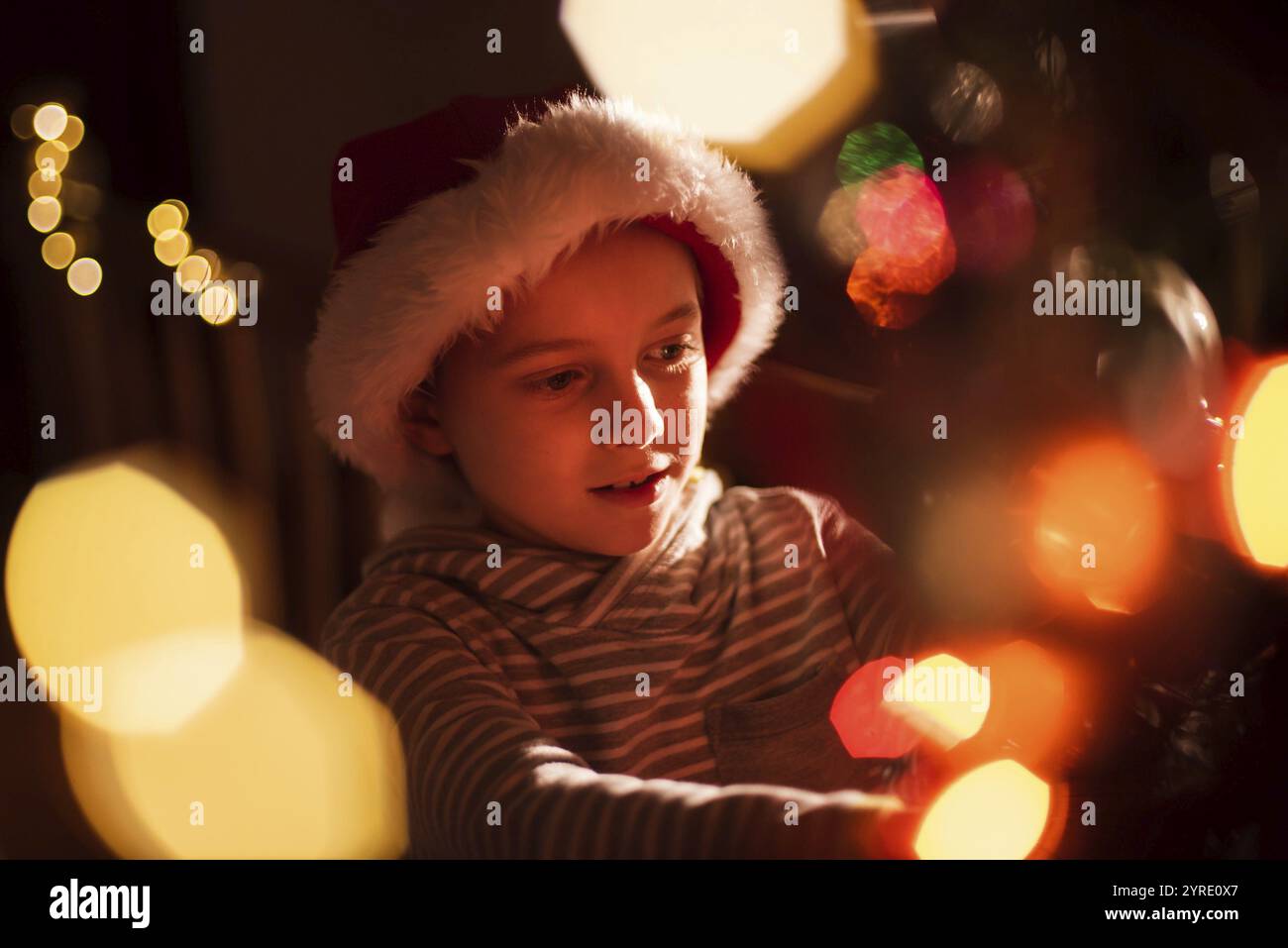Portrait of 8 years old boy decorating Christmas tree Stock Photo - Alamy