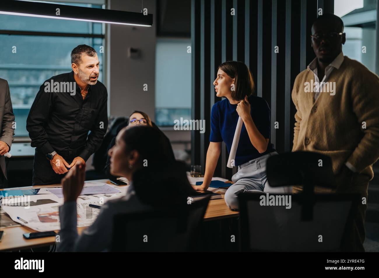 Diverse team engaging in a collaborative office meeting discussion ...