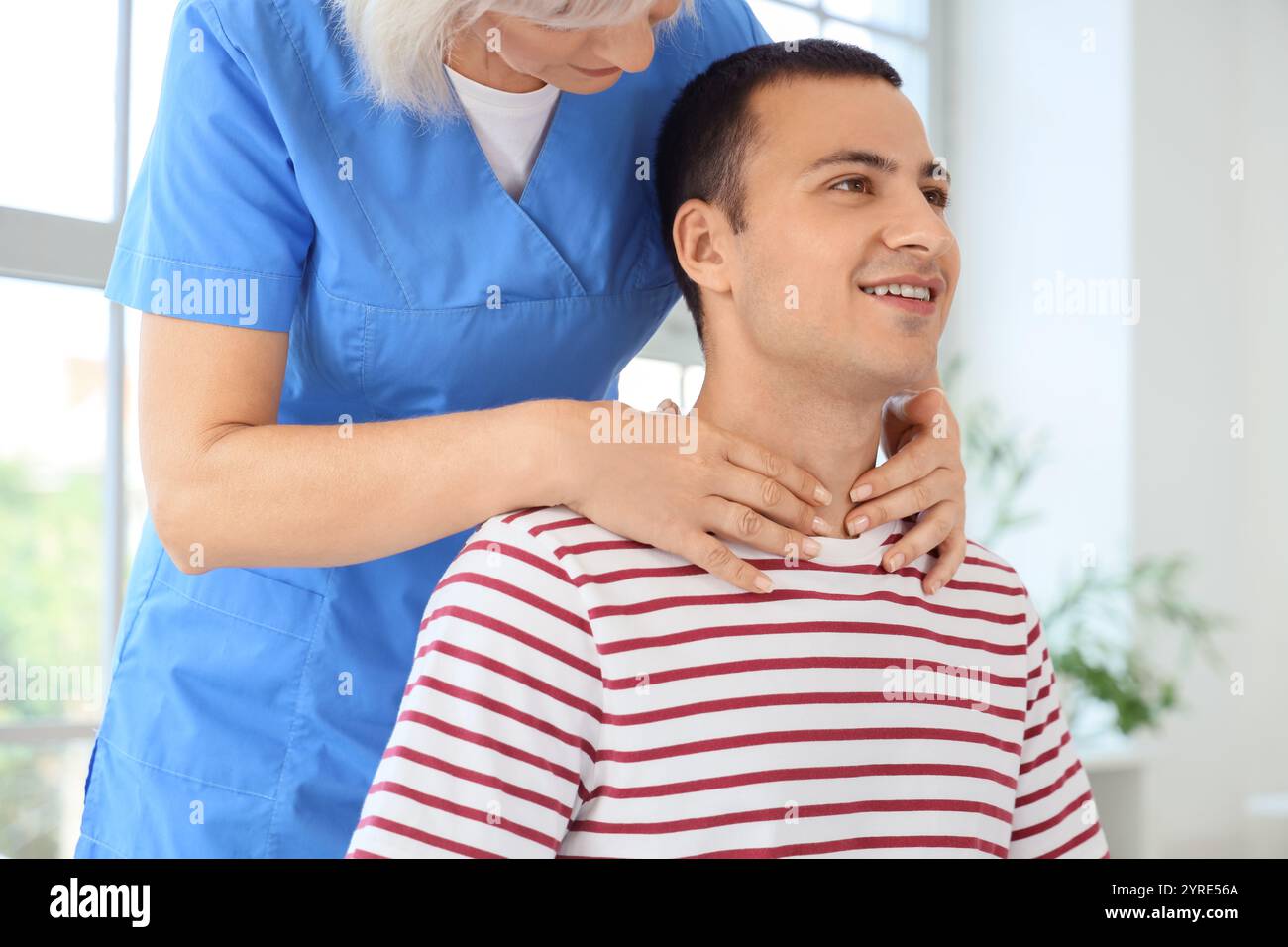 Female endocrinologist examining young hi-res stock photography and ...