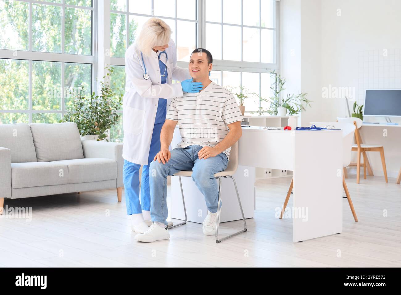 Female endocrinologist examining young hi-res stock photography and ...