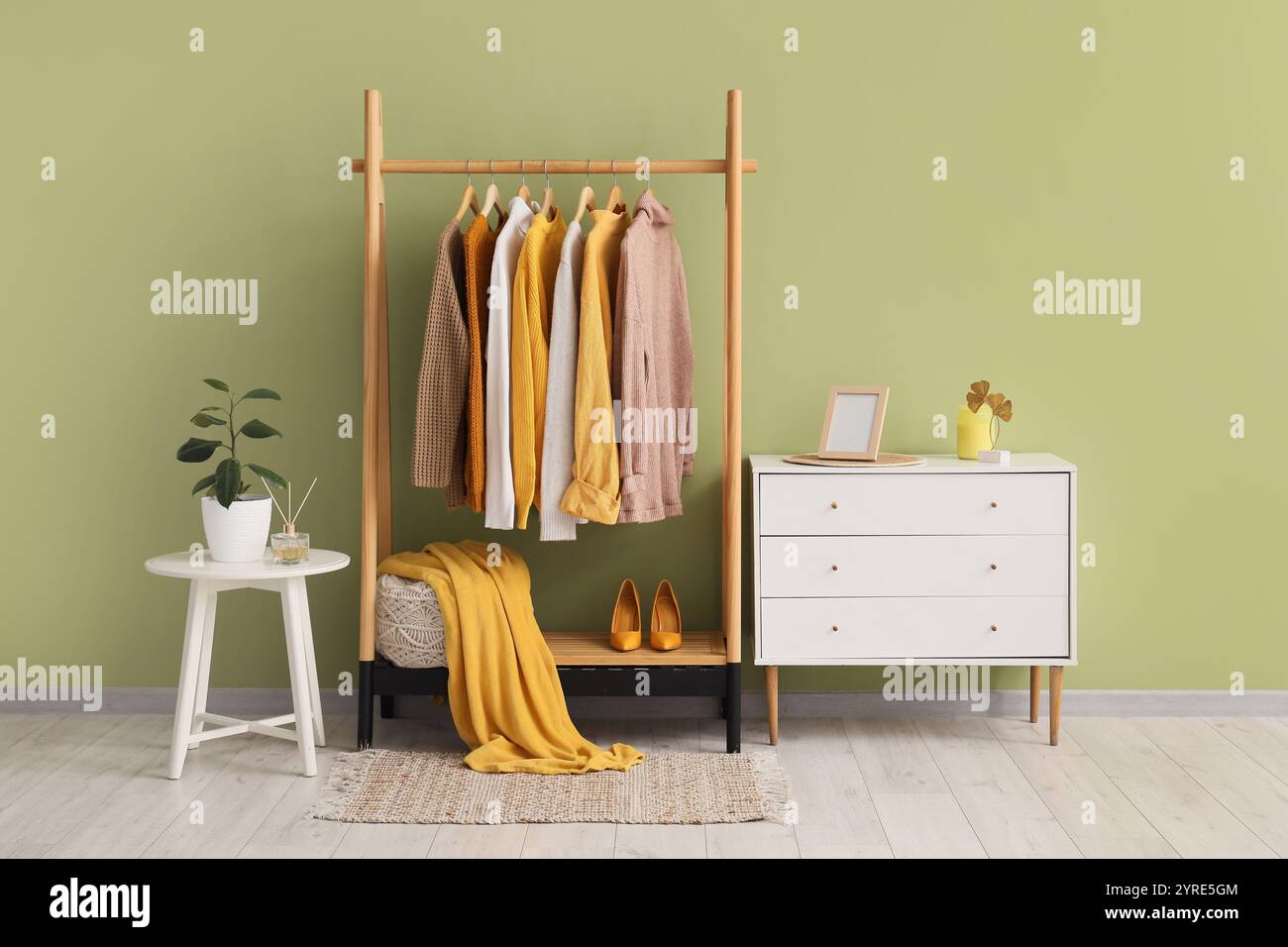 Interior of dressing room with clothes rack, table and drawers Stock ...