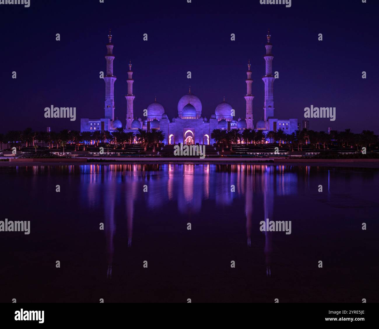 Sheikh Zayed Grand Mosque glowing in radiant purple at night ...