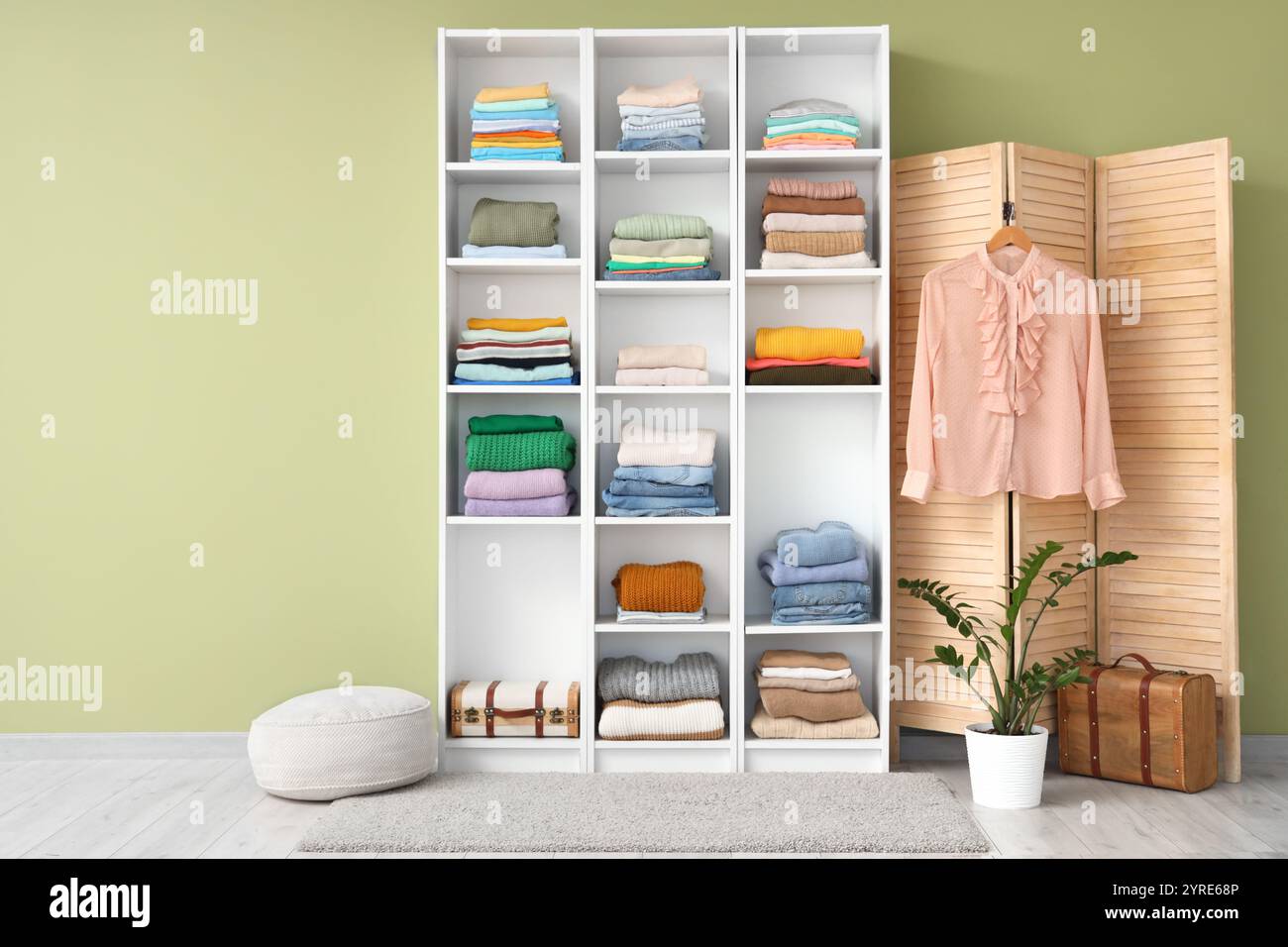 Wardrobe and folding screen in interior of dressing room Stock Photo ...