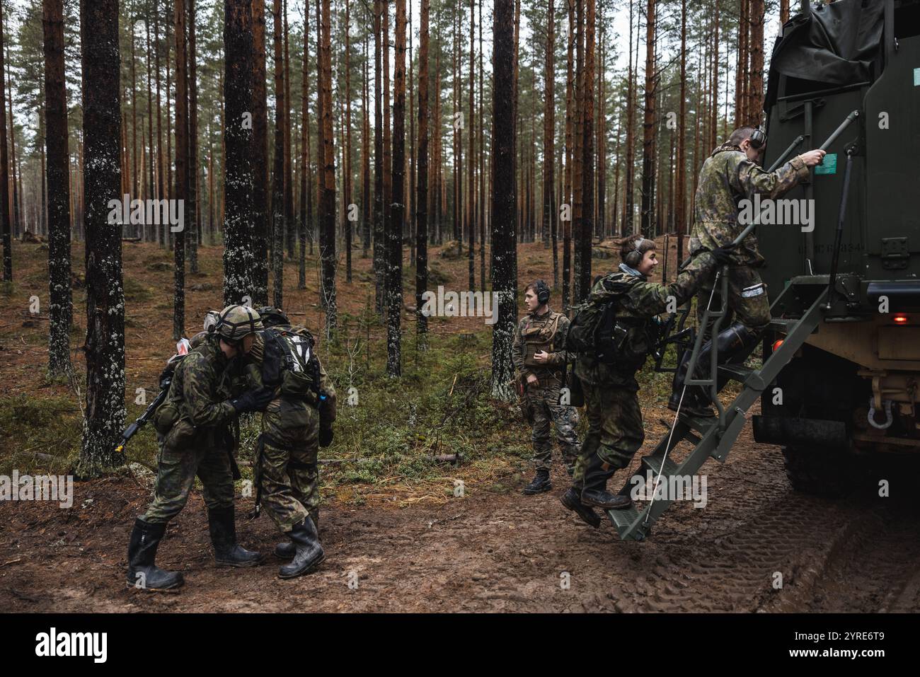 U.S. Marines and Finnish servicemembers load simulated casualties onto ...
