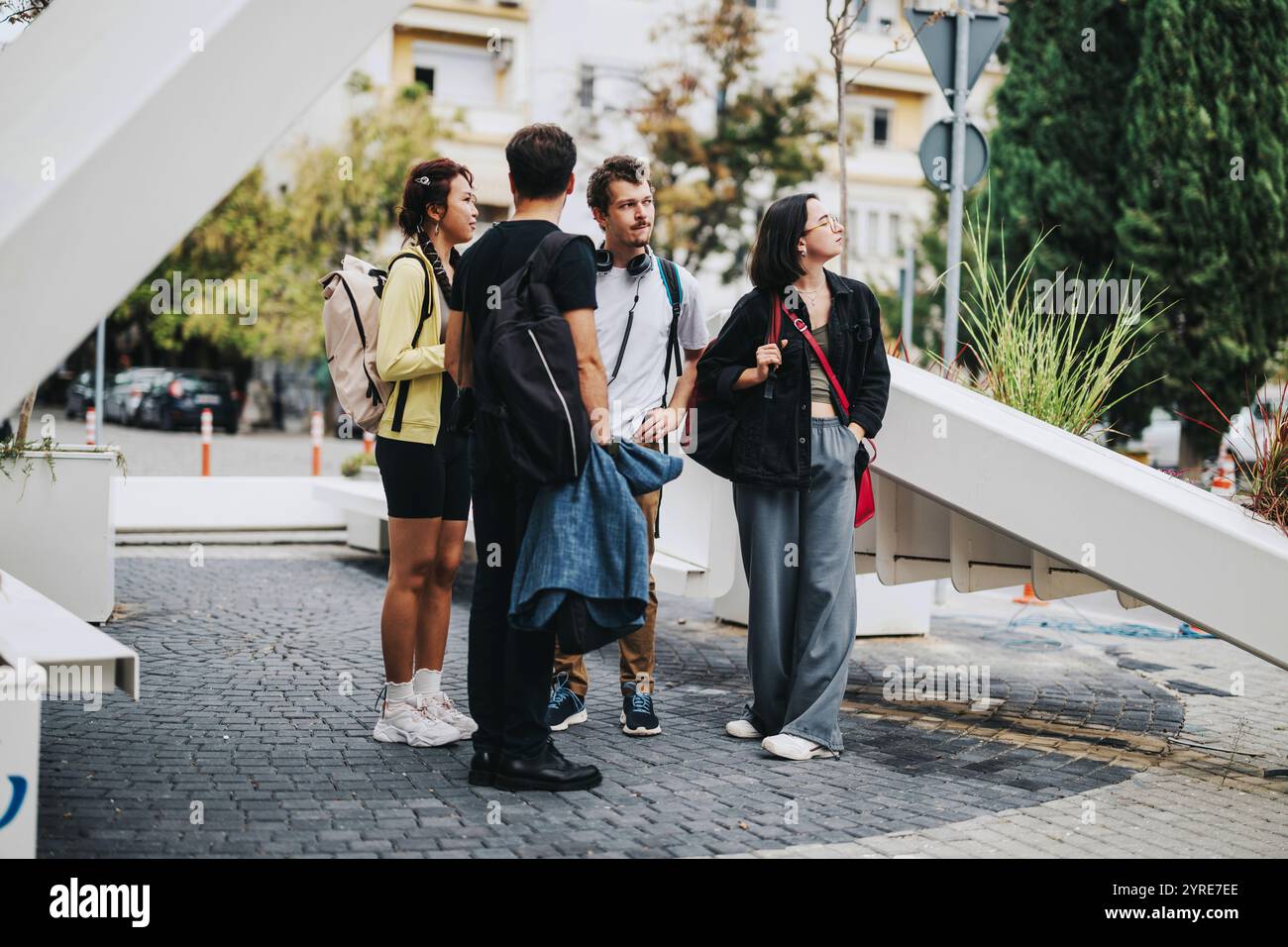 Group of young adults exploring an urban outdoor environment Stock ...