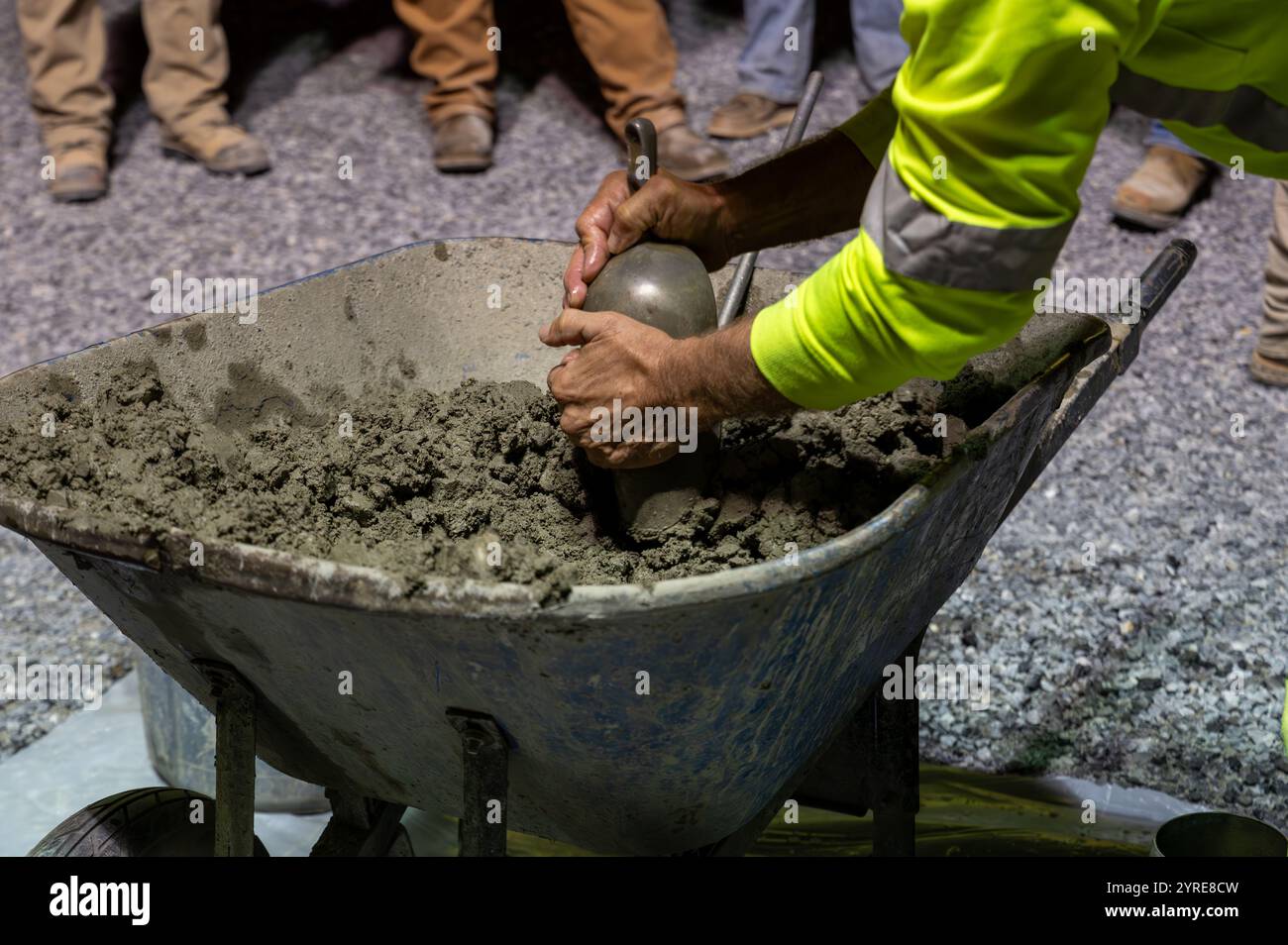 A contractor prepares a sample of concrete for a slump test at Tyndall ...