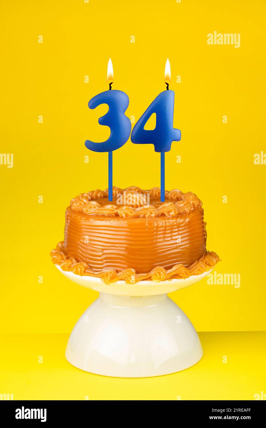 Number 34 Candle - Happy Birthday Cake on a yellow background Stock ...