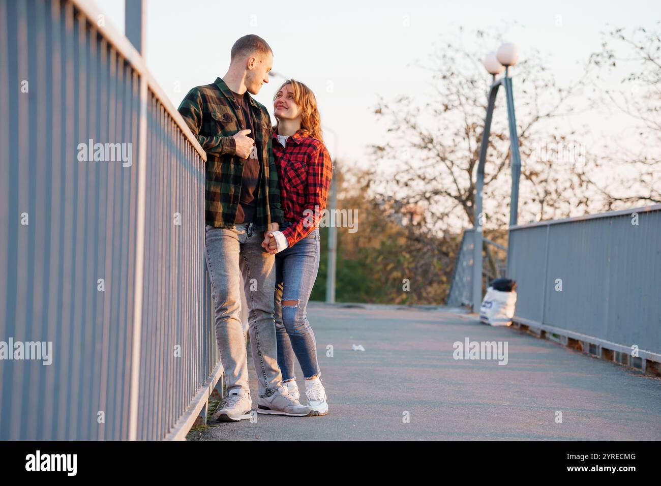 Romantic Moment on a Sunset Bridge Stock Photo - Alamy