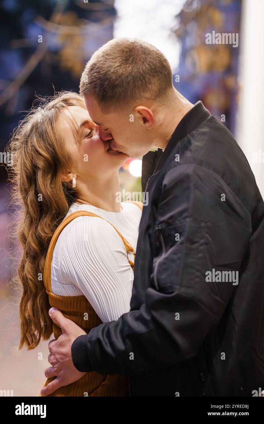 Romantic Embrace: A Young Couple Shares a Tender Kiss in an Intimate ...