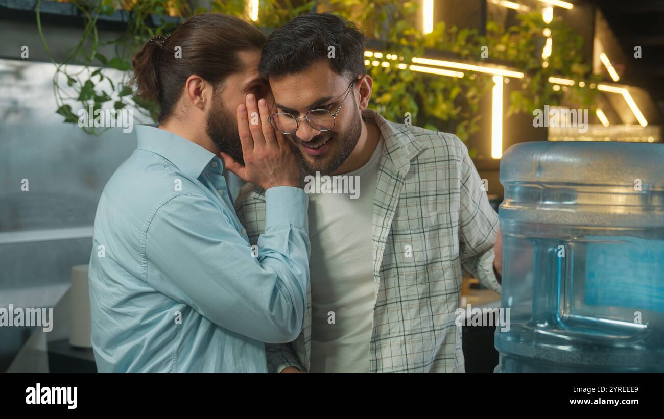 Arabian man drink water cooler in office coffee break pause two ...