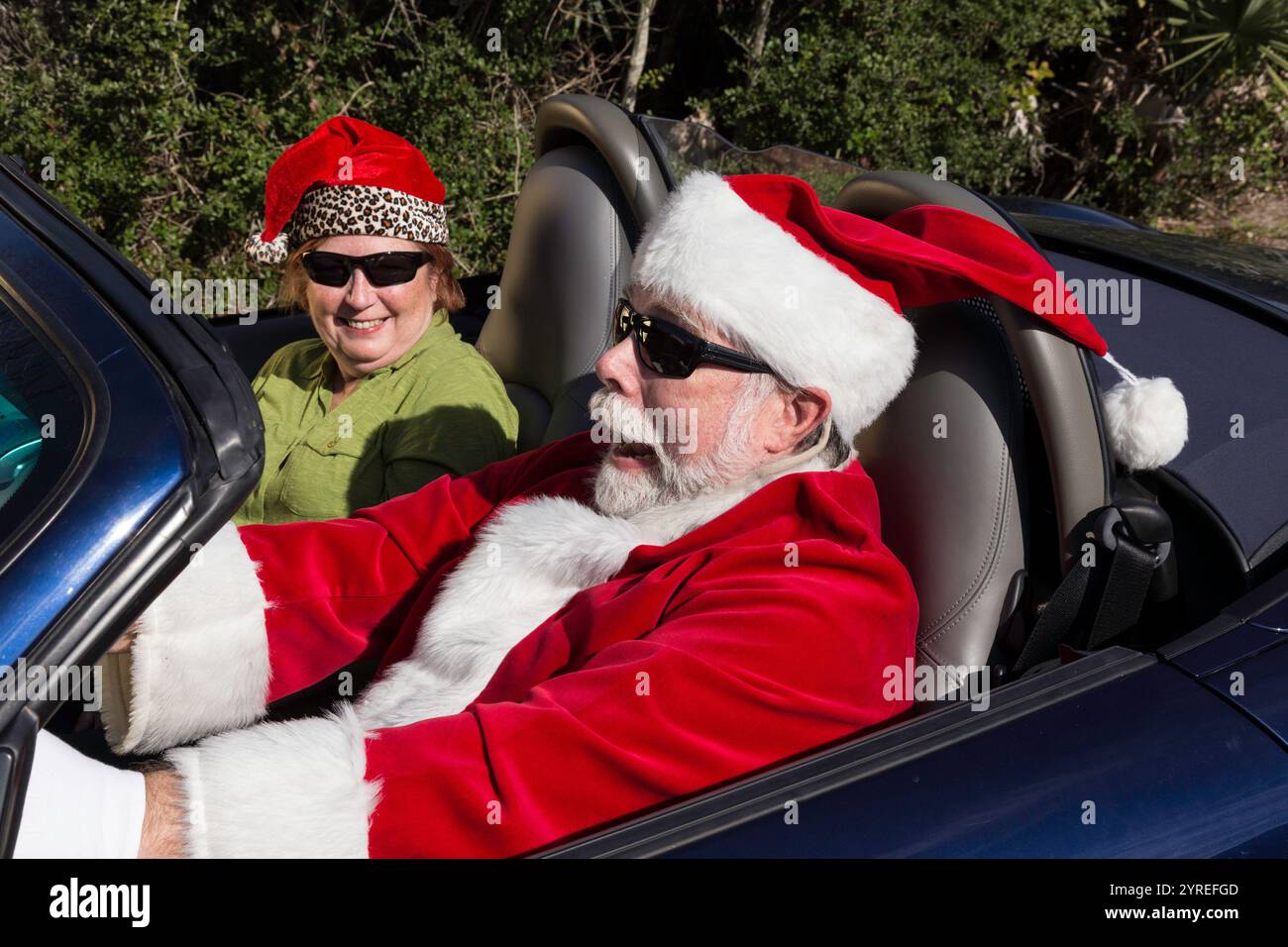Santa and Mrs. Claus Driving in a convertible while on Vacation in ...