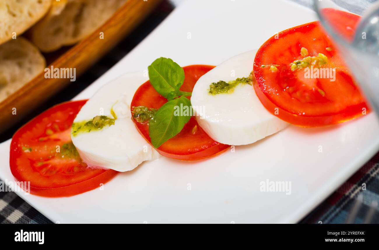 Caprese salad with fresh tomatoes, mozzarella cheese and basilic herb ...