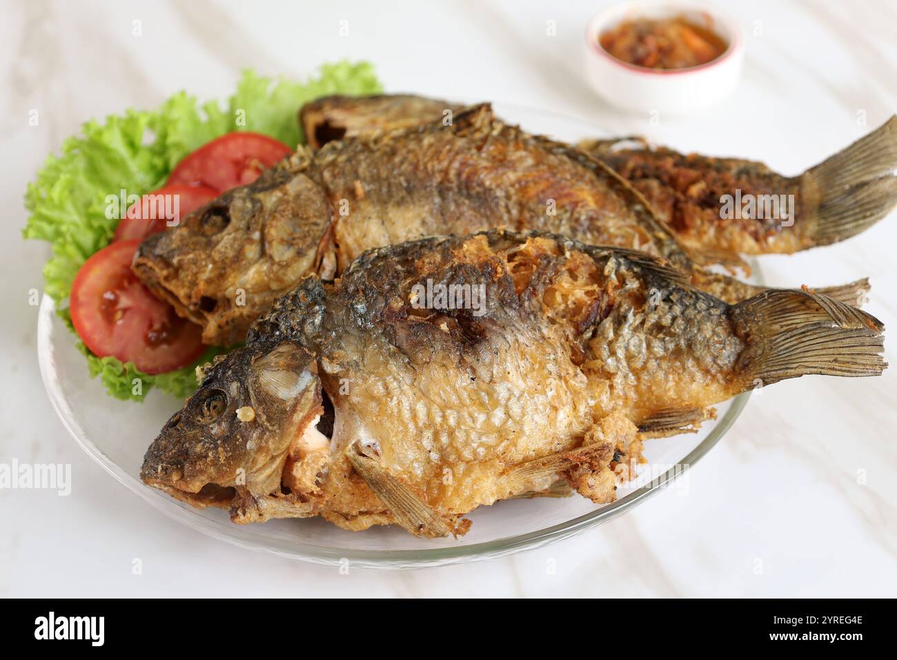 Fried Golden Fish on Glass Plate, Ikan Mas Goreng Stock Photo - Alamy