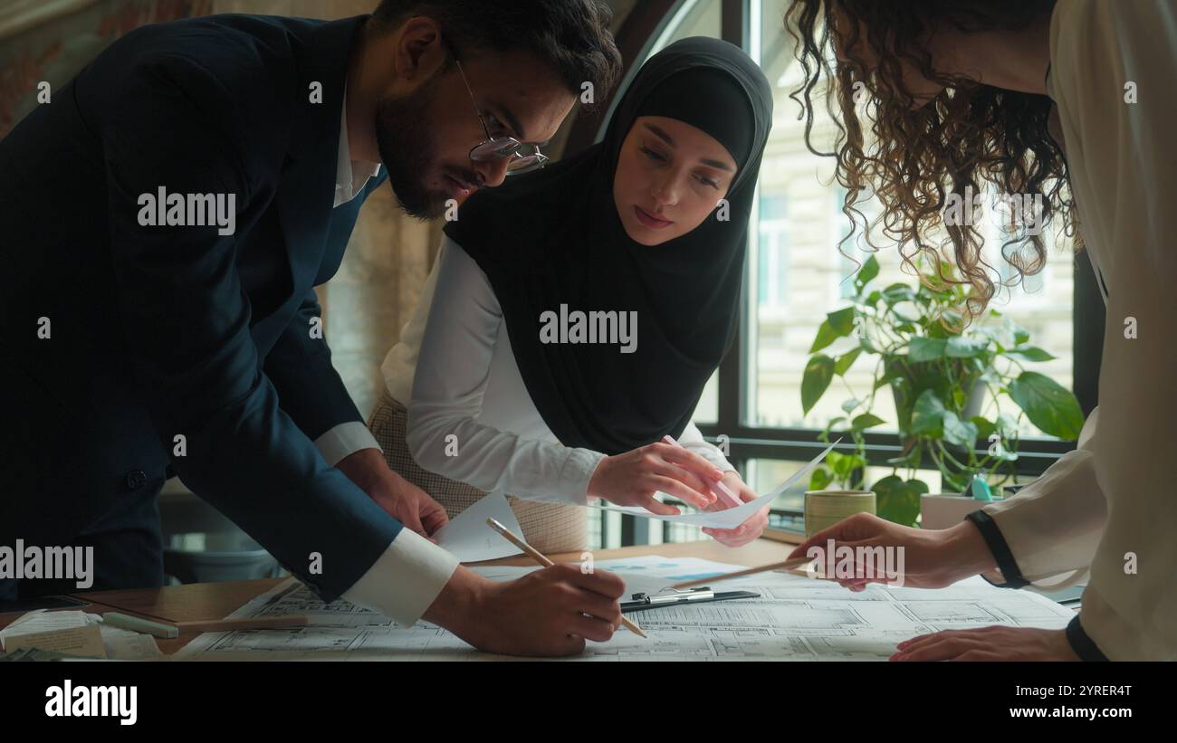 Office team architects designers civil engineers drawing building plan architecture blueprints ...