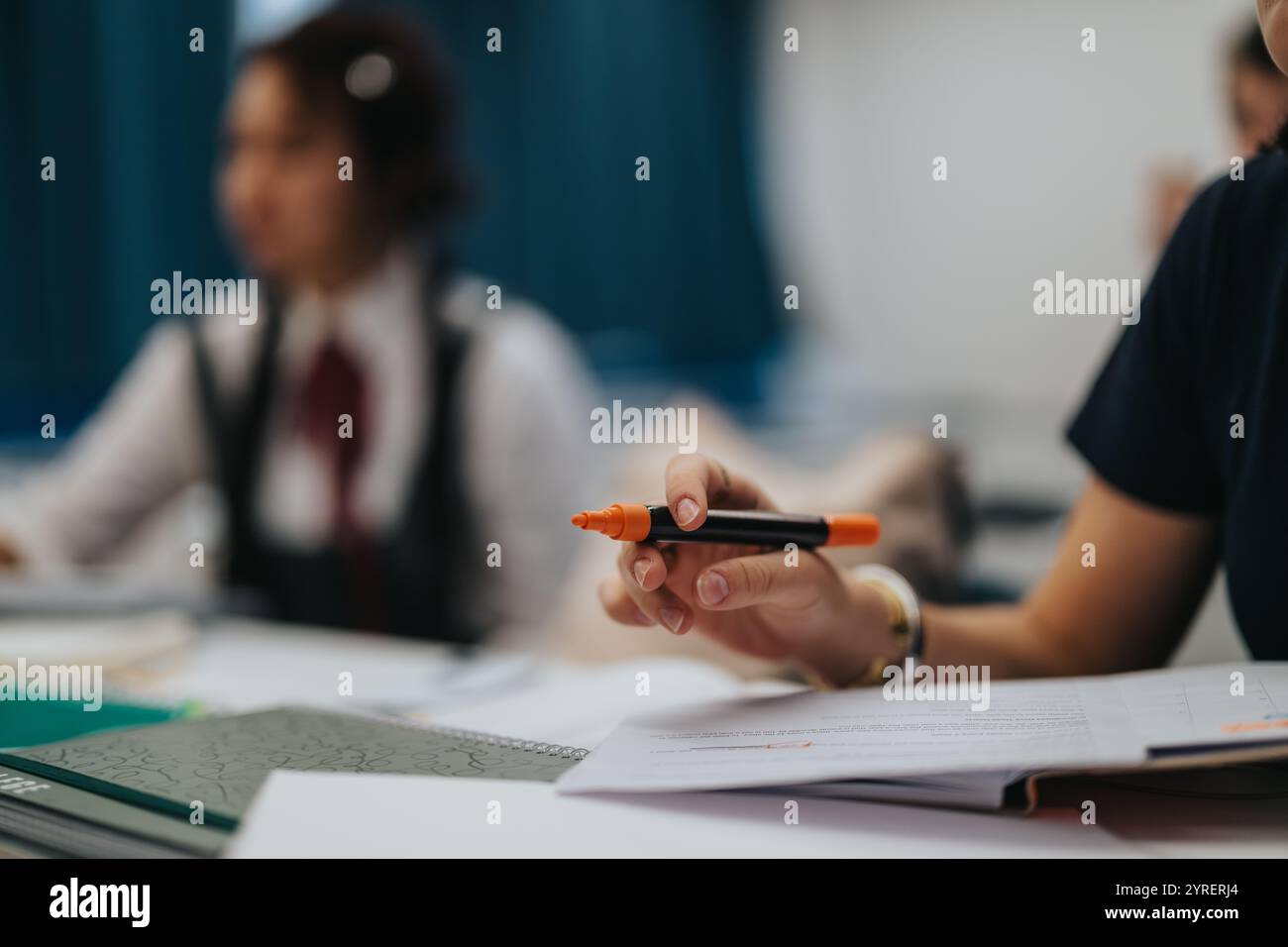 Students engaging in class tasks with supportive professor assistance ...