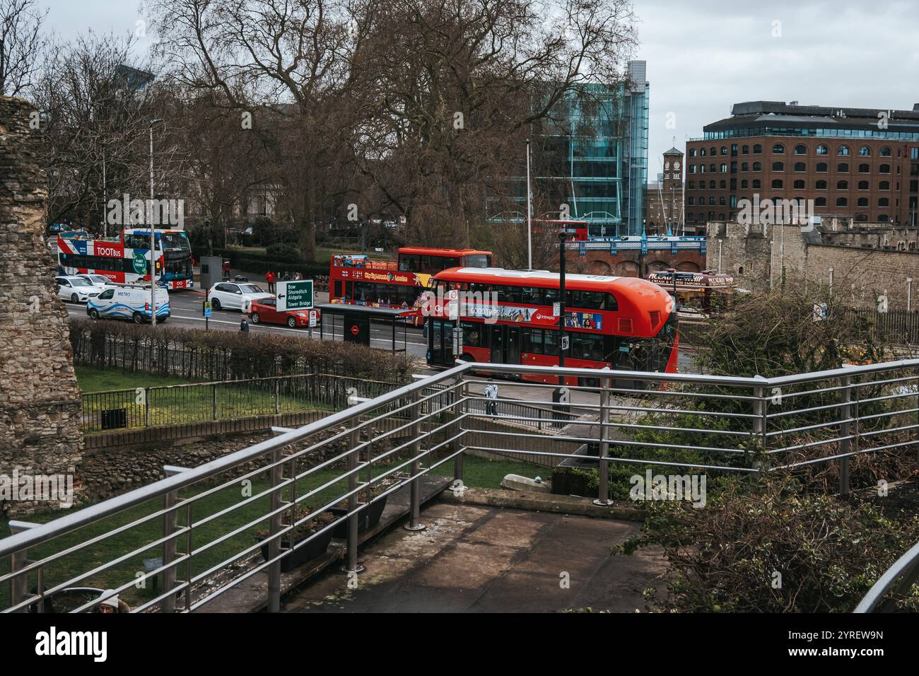 Iconic double-decker buses move through the bustling streets of London ...