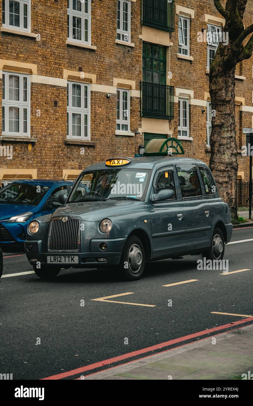 A classic London cab on the bustling streets of London, representing ...