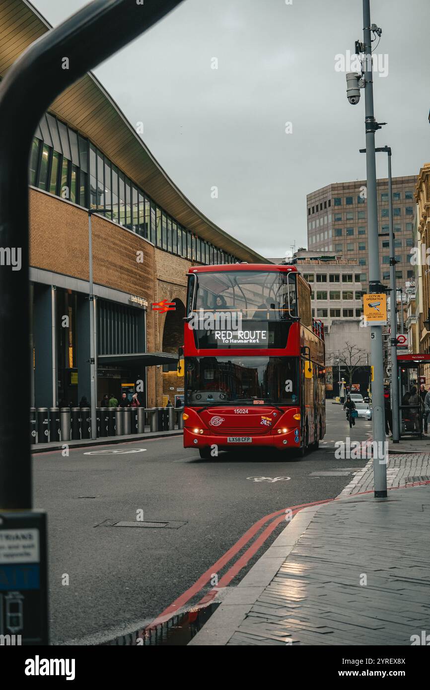 Iconic double-decker buses move through the bustling streets of London ...
