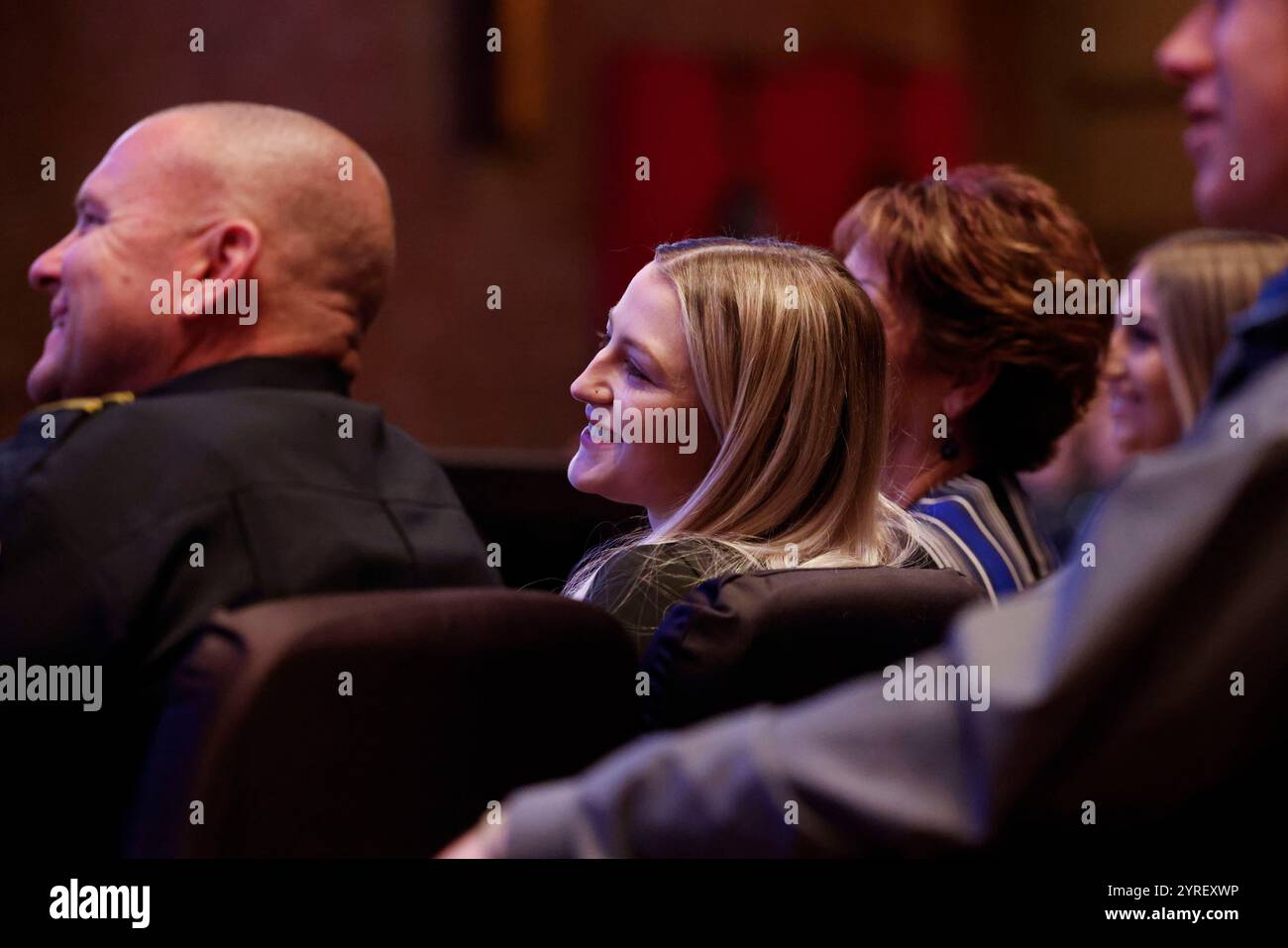 Aubrey Dawson, reacts to a slideshow shown during the funeral service ...