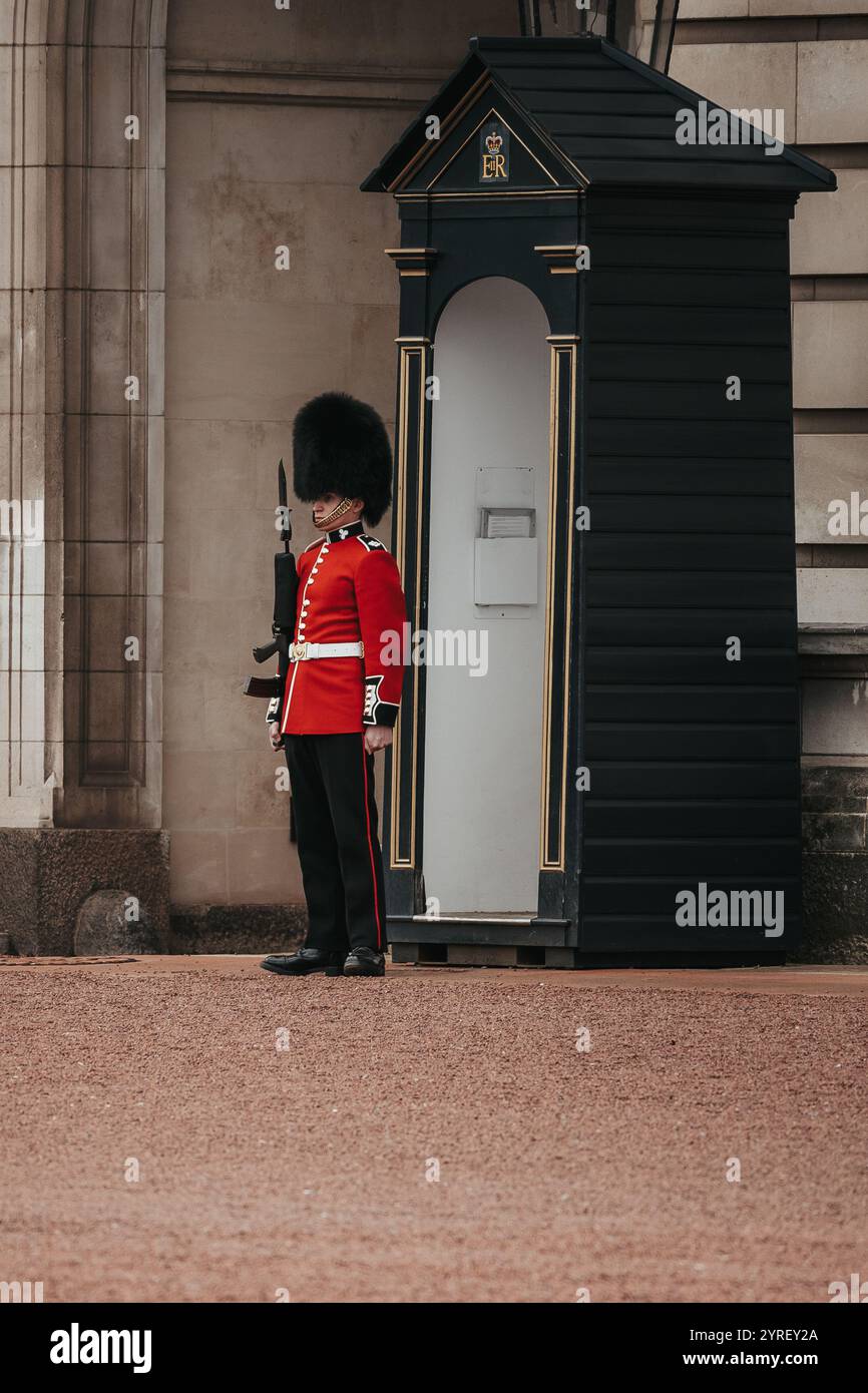 A royal guard stands in front of Buckingham Palace in London ...