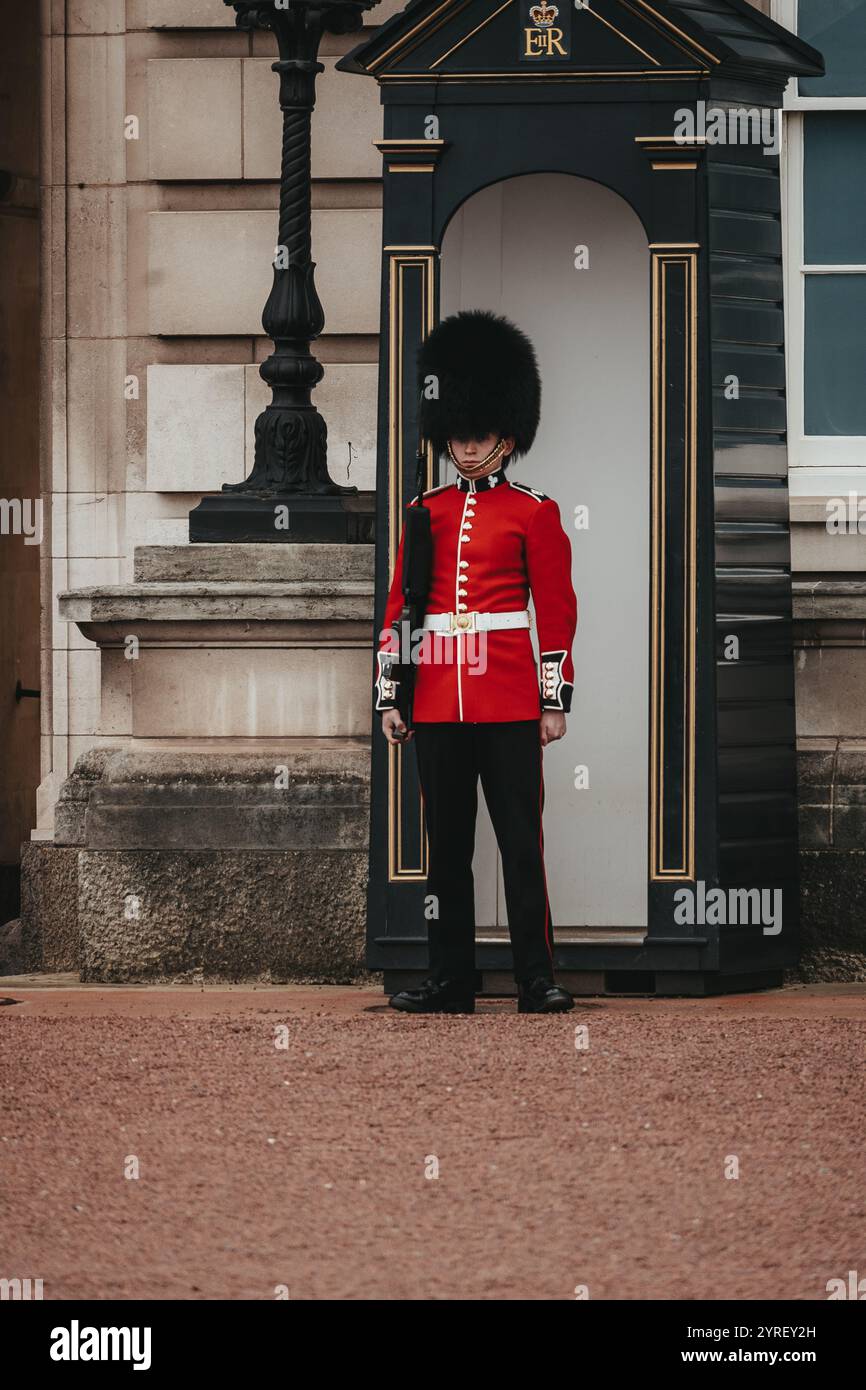 A royal guard stands in front of Buckingham Palace in London ...