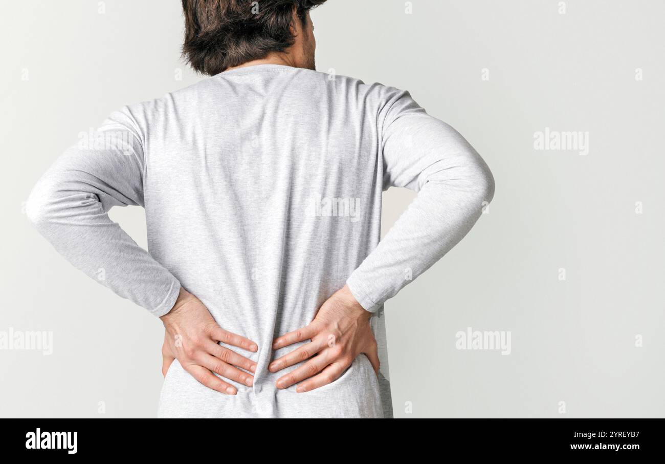 Body ache and kidneys pain. Man presses his hands to back Stock Photo ...