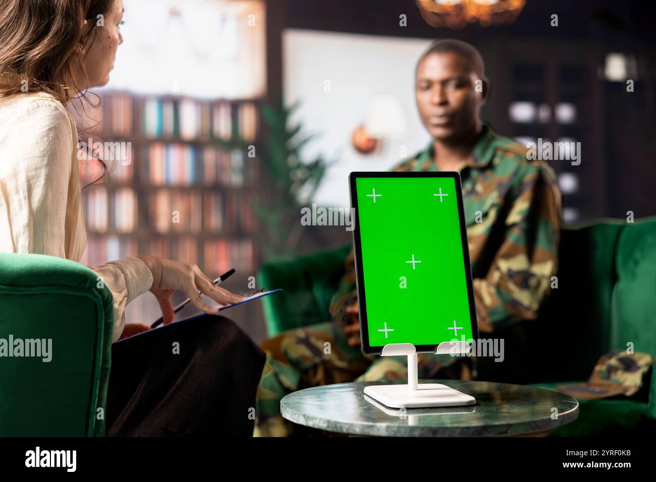 Psychotherapy session for a military veteran in distress with mockup ...